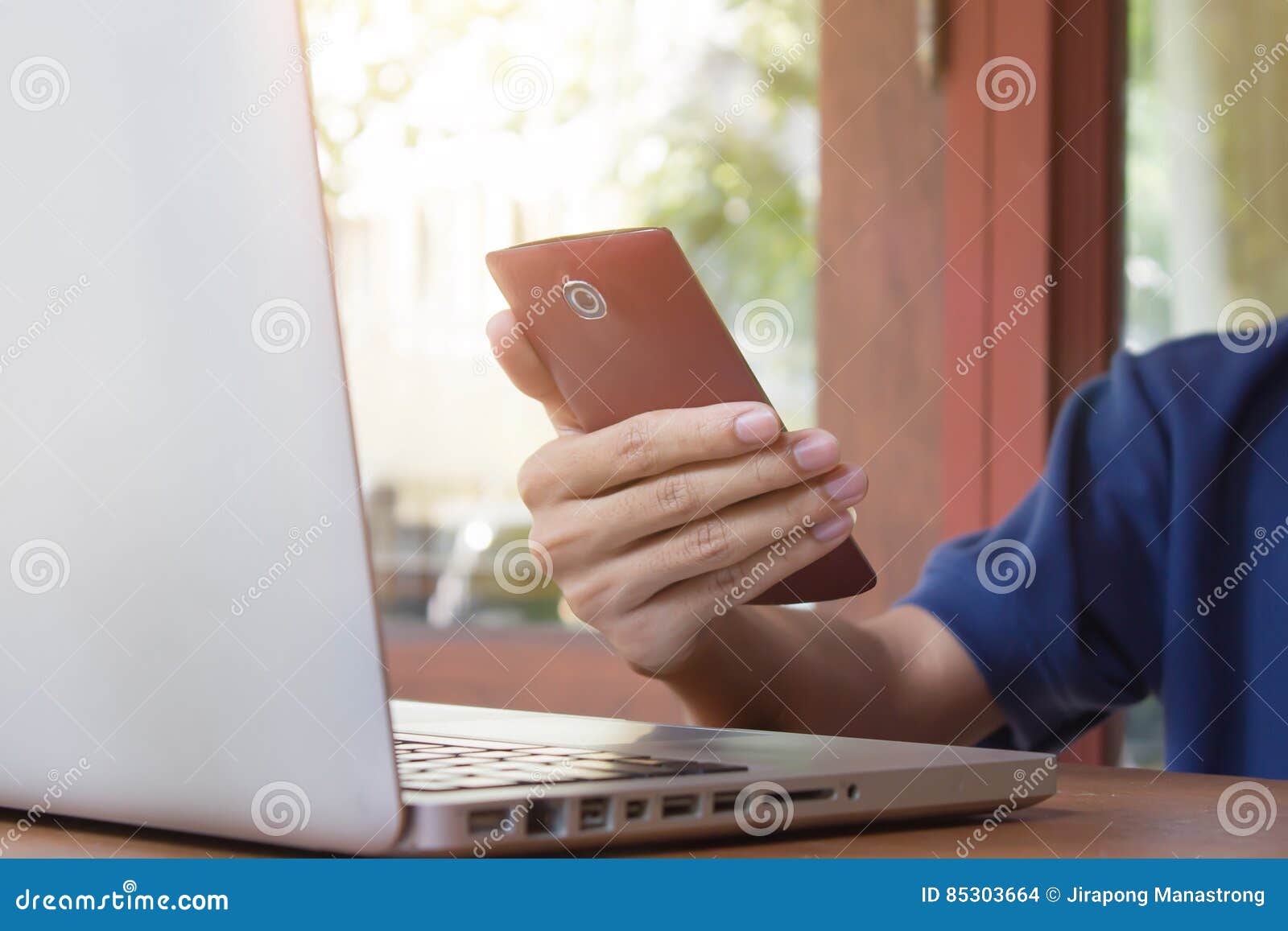 Man Using Mobile Phone and Laptop at Morning.. Stock Photo - Image of ...