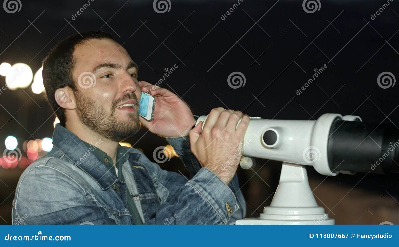 Man Using Mobile Phone and Looking into a Tower Viewer Stock Image ...