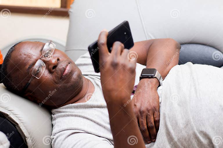 Man Using Mobile Phone Lying Down Stock Photo - Image of holding ...