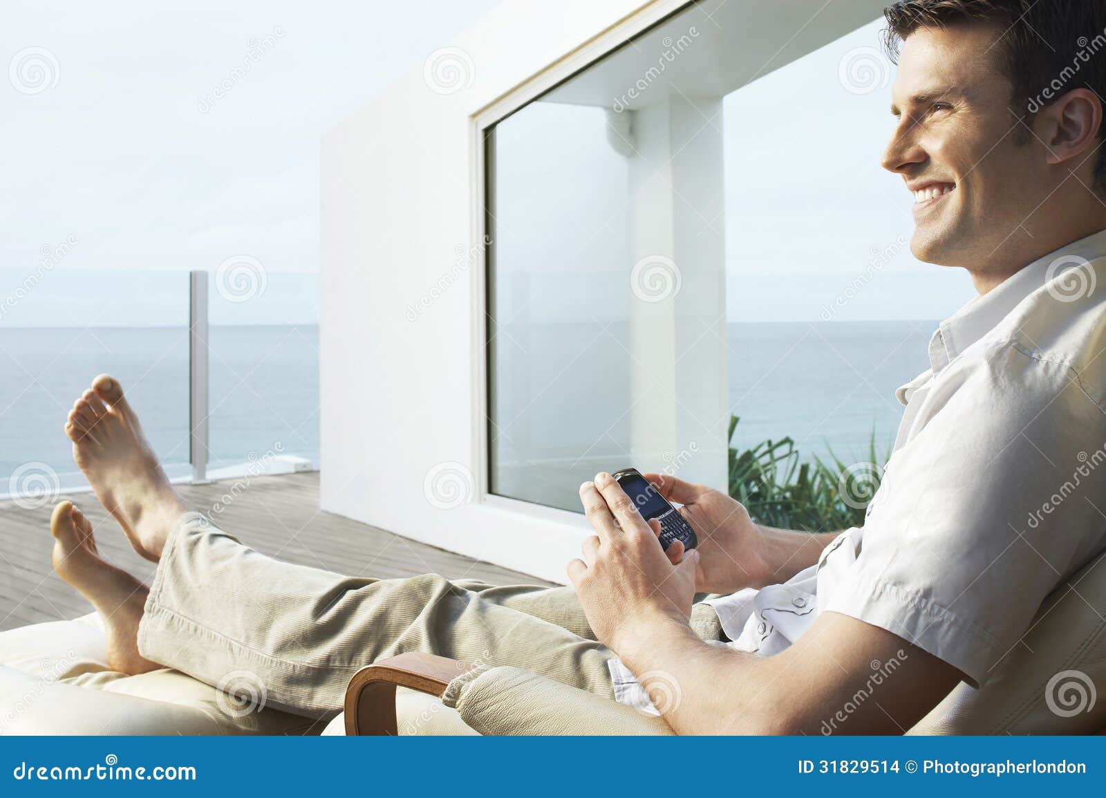 Man Using Mobile Phone on Porch Stock Photo - Image of looking, leisure ...