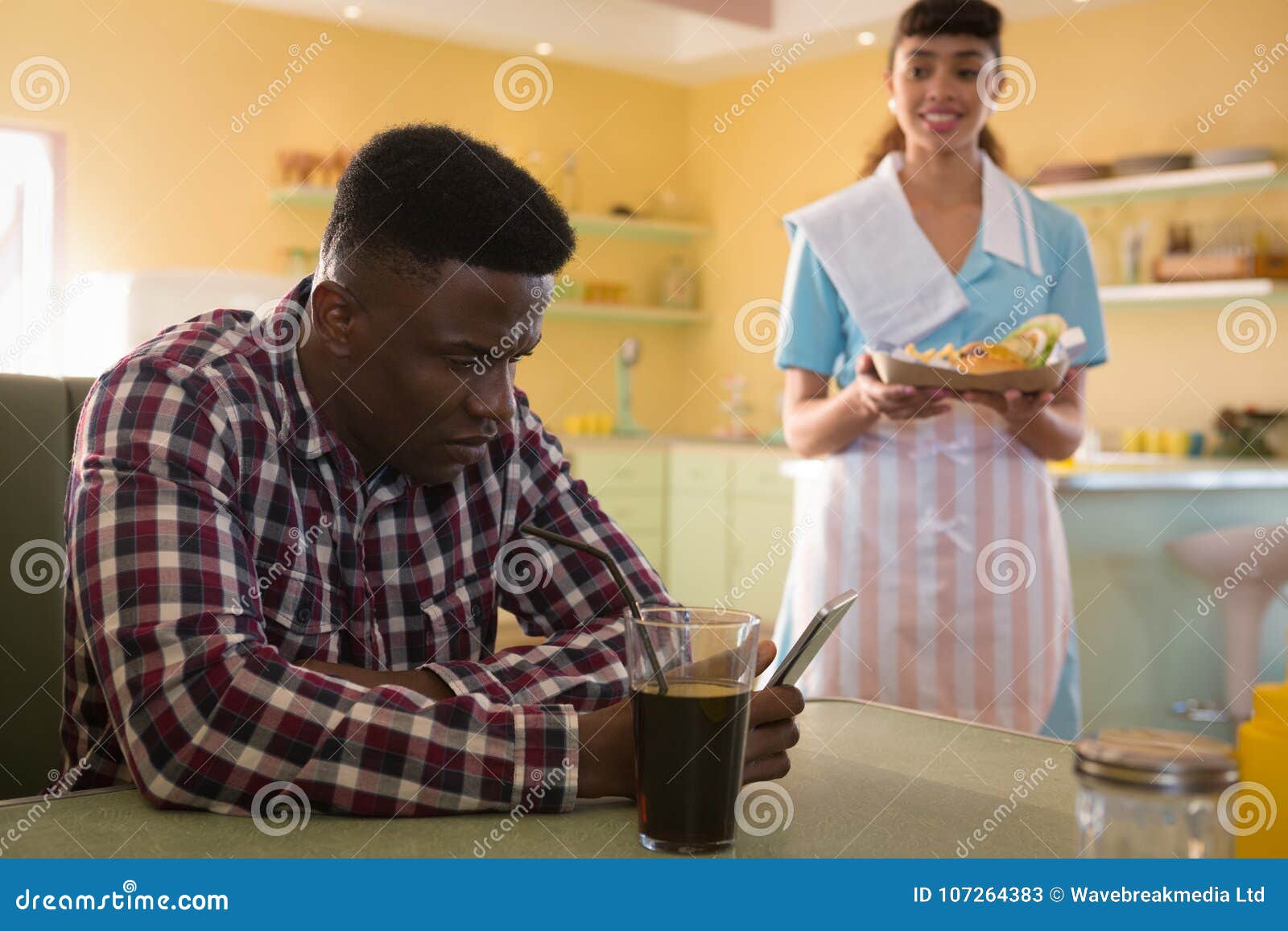 Man Using Mobile Phone while Waitress Serving Breakfast Stock Image ...
