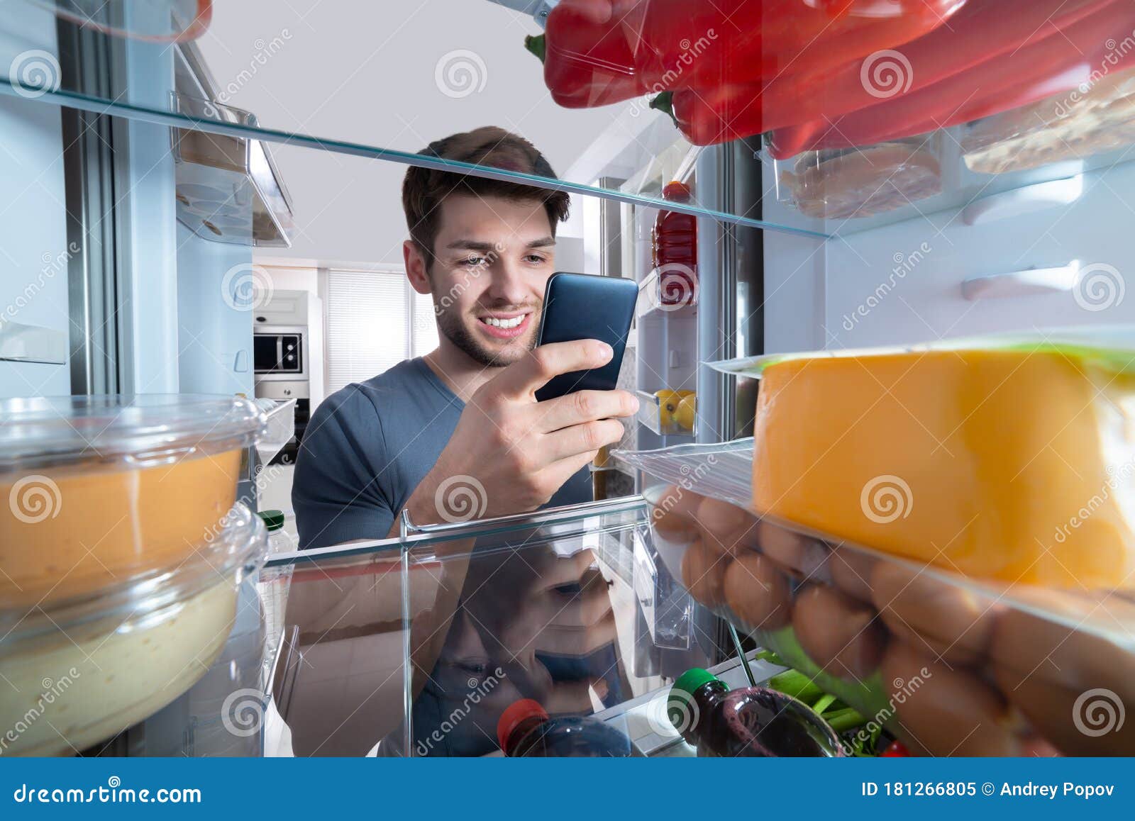 Man Using Mobilephone in Front of Refrigerator Stock Image - Image of ...