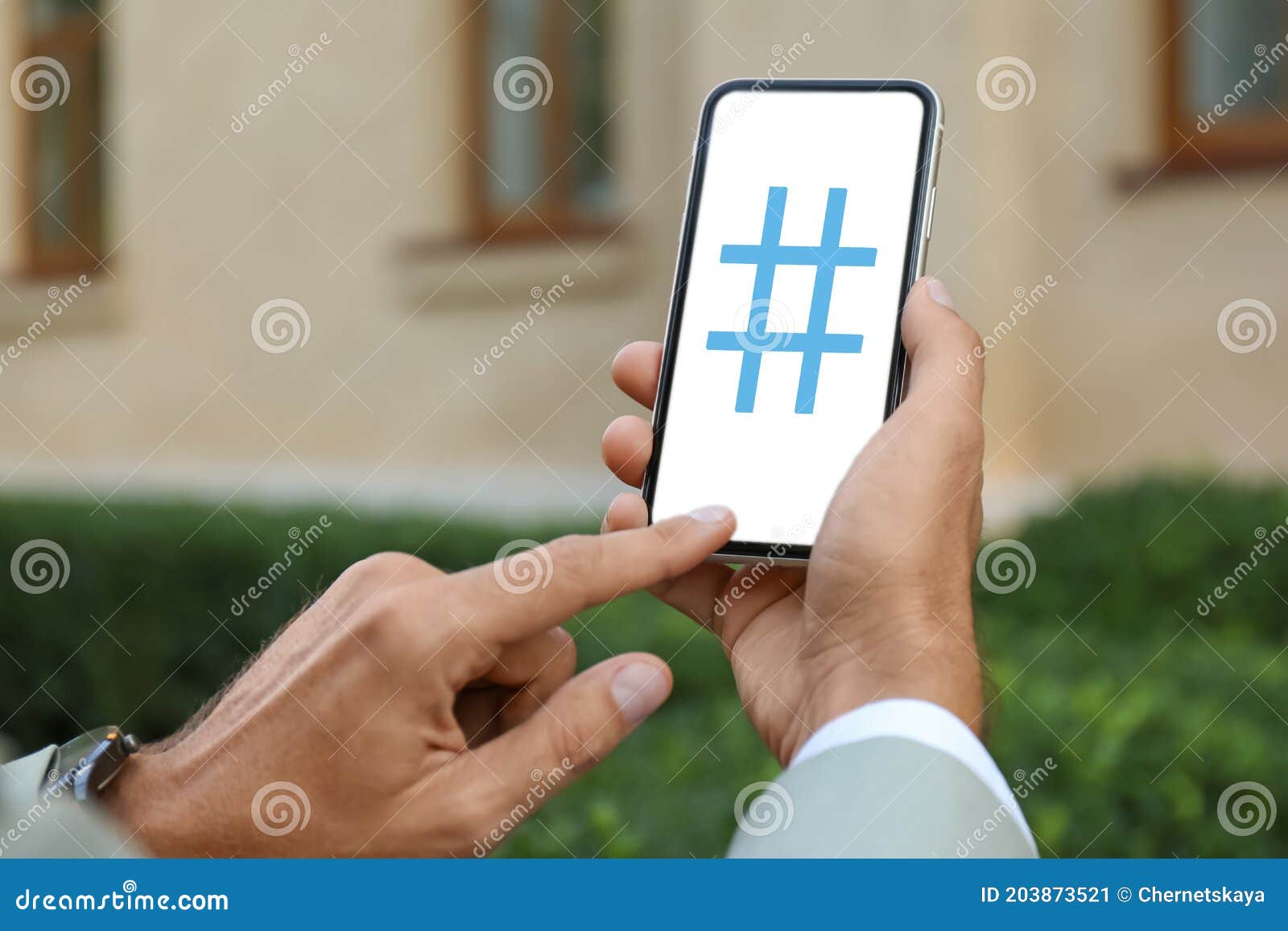Man Using Modern Smartphone with Hashtag Symbol on Screen Outdoors ...