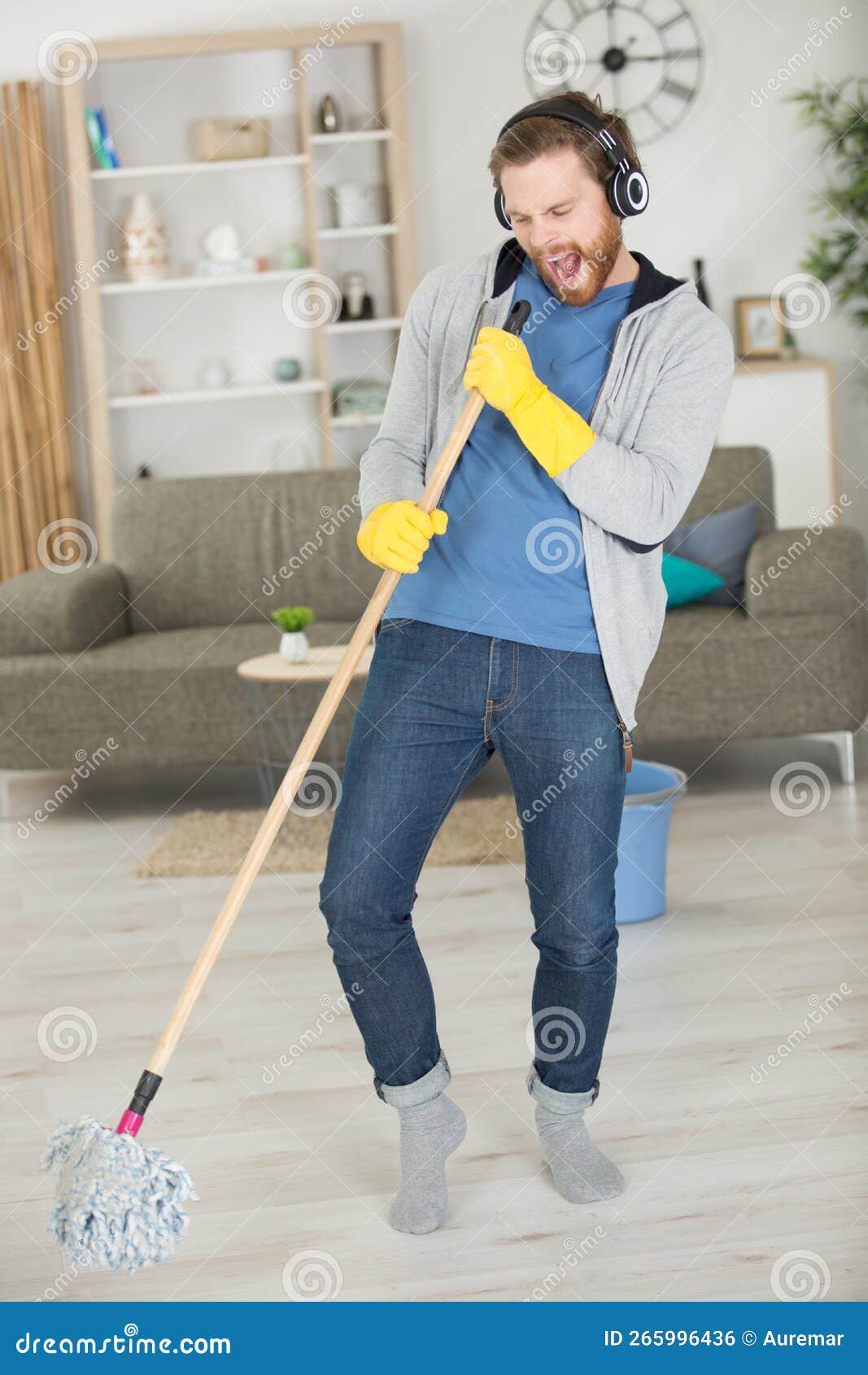 Man Using Mop As Microphone while Doing Housework Stock Photo - Image ...