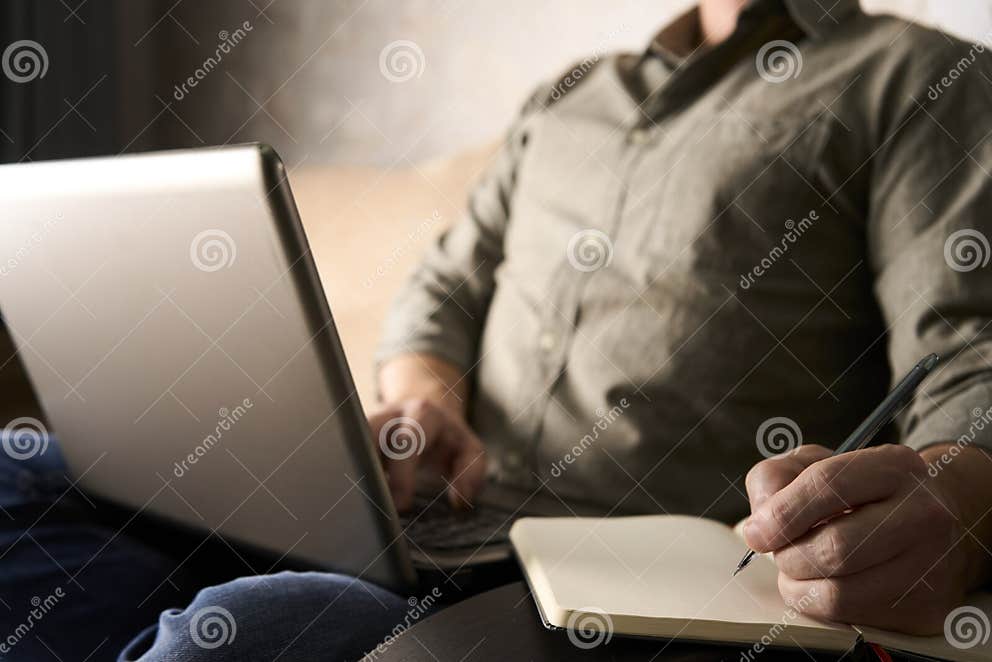 Man Using on Notebook and Working on Laptop Computer Stock Image ...