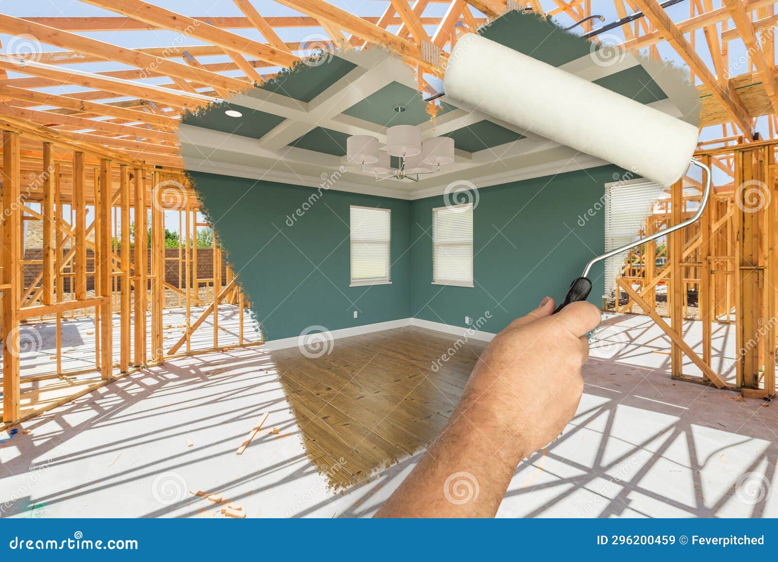 Man Using Paint Roller To Expose Finished Build of House Construction ...