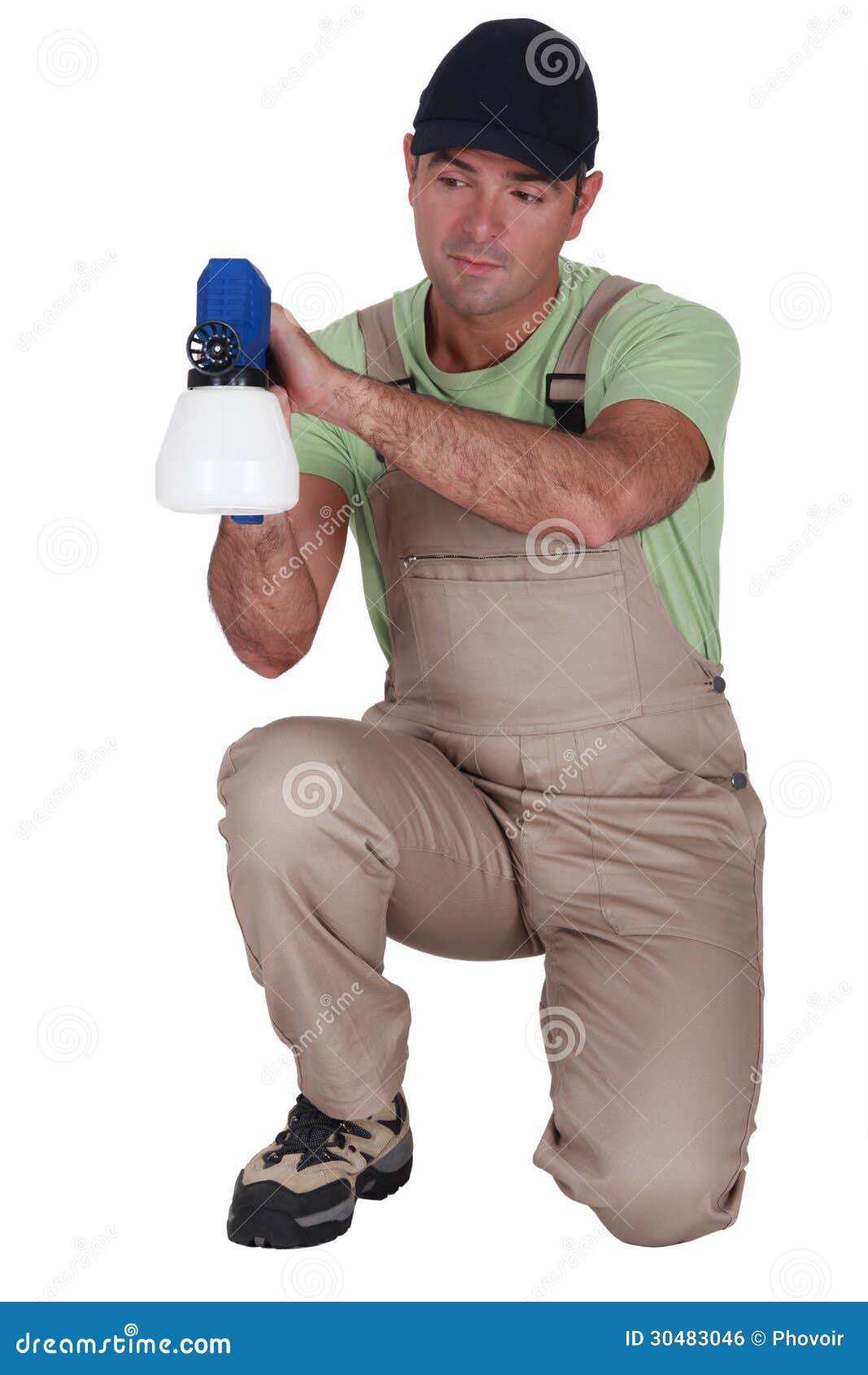 Man using paint sprayer stock photo. Image of kneeling - 30483046