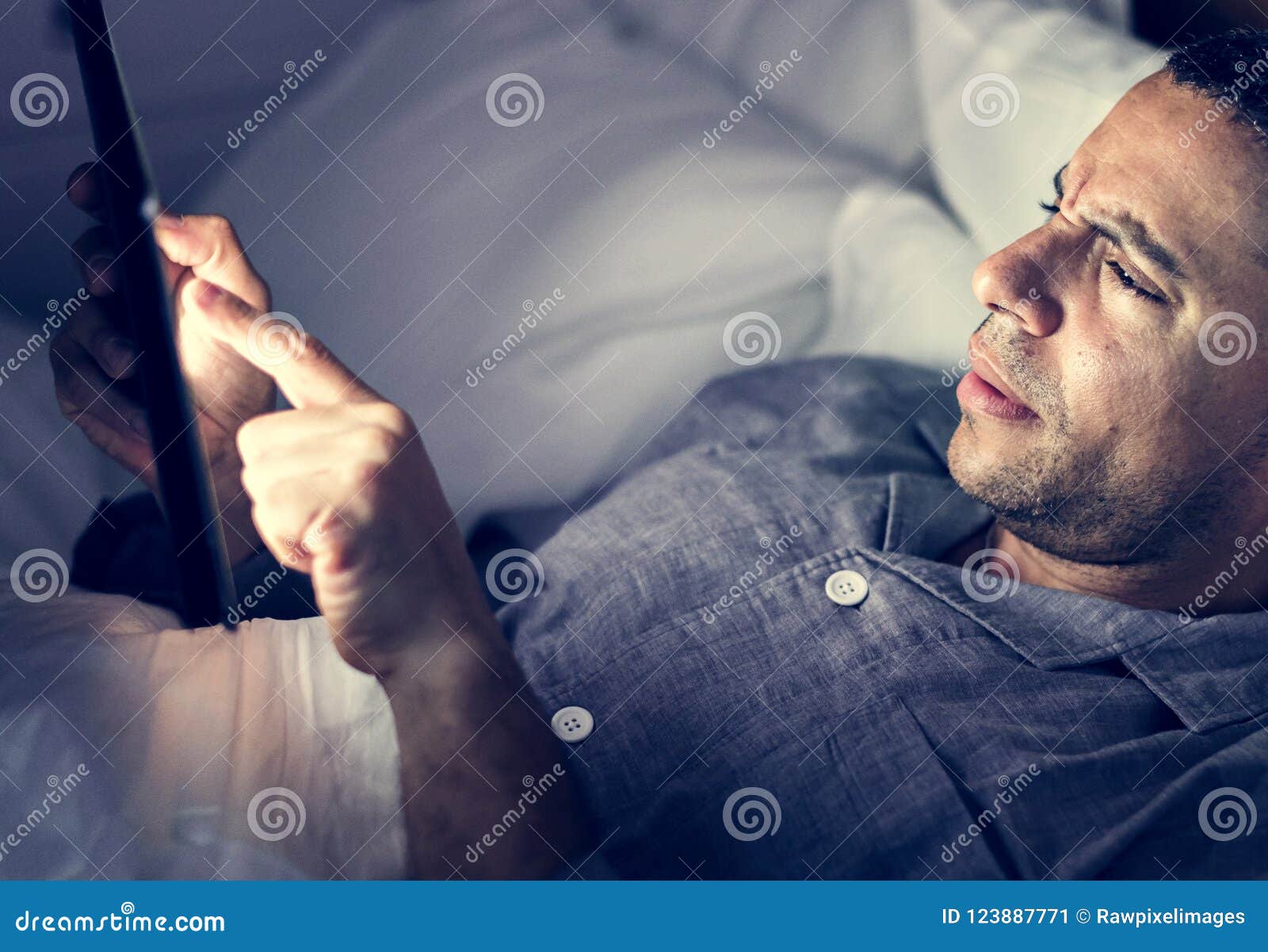 Man using phone on a bed stock image. Image of exhausted - 123887771