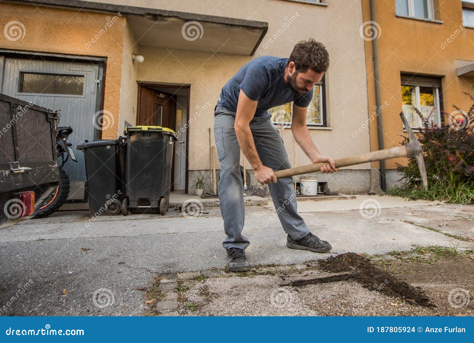 Man Using a Pick at a Construction Site Stock Photo - Image of green ...