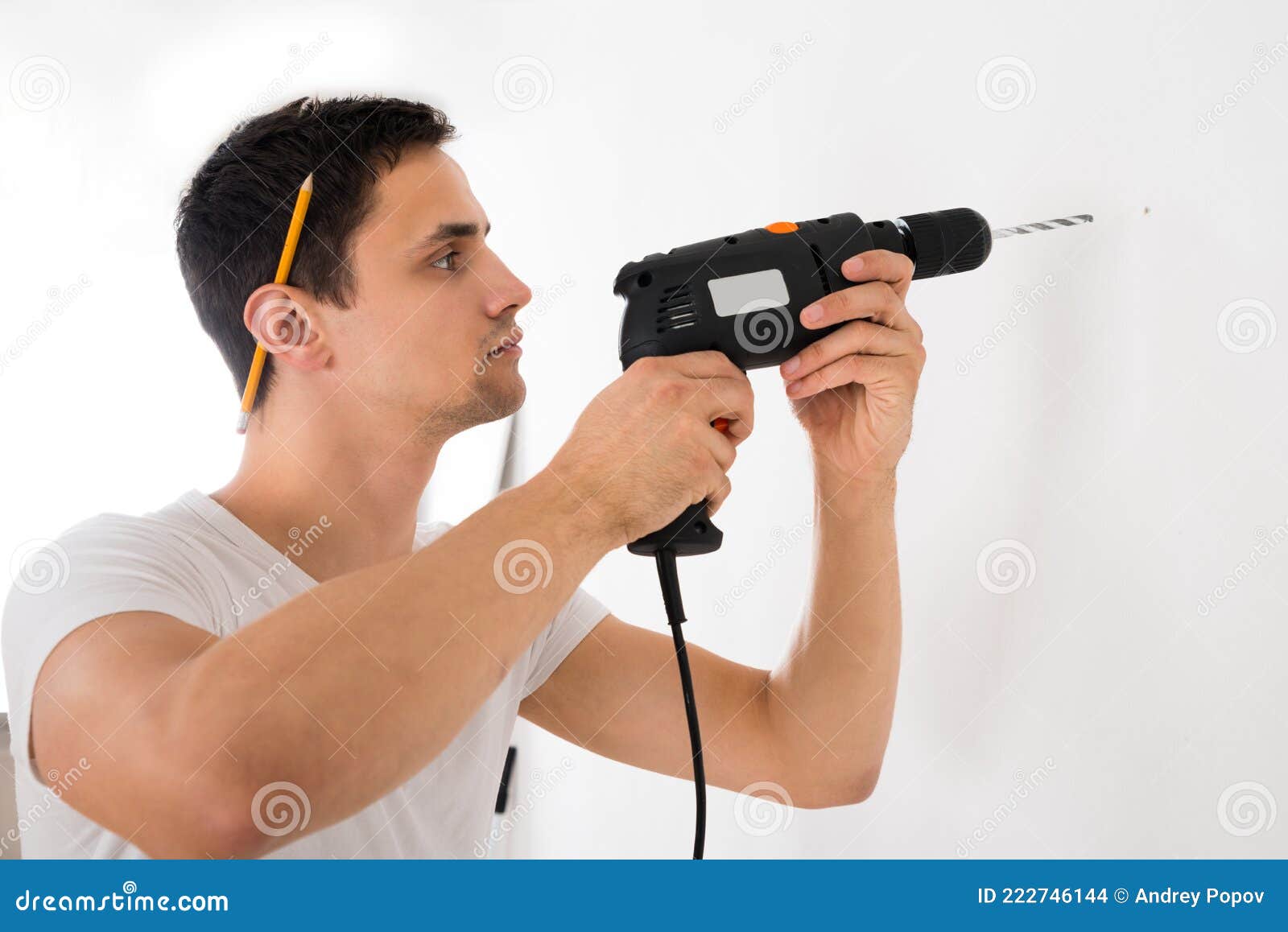 Man Using Power Drill on White Wall Stock Photo - Image of home ...