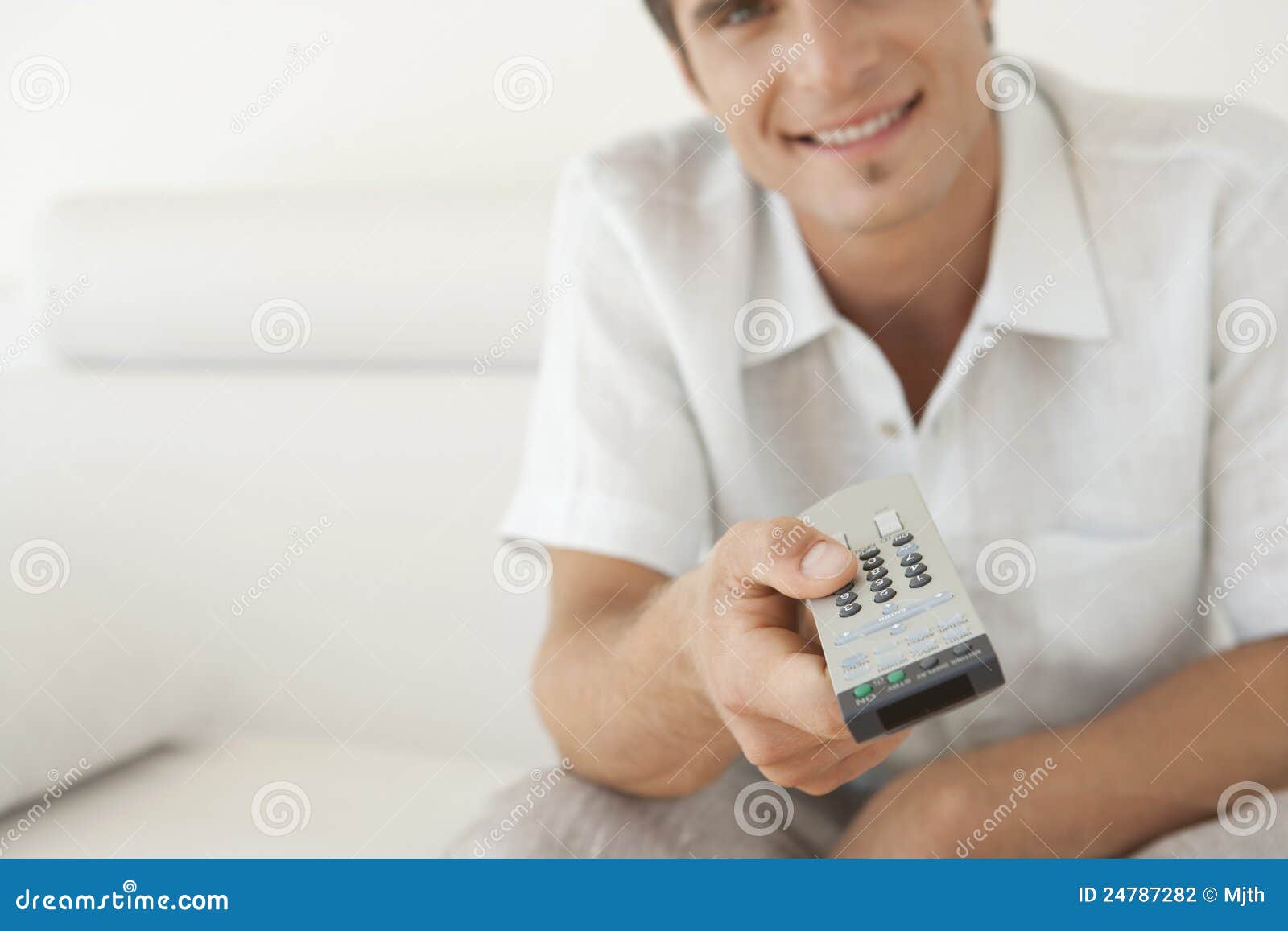 Man Using a Remote Control stock photo. Image of home - 24787282