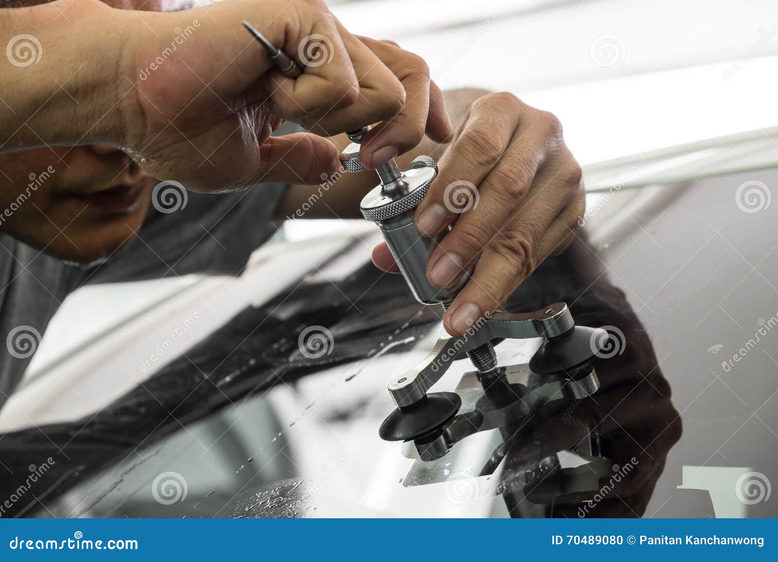 A Man Using Repairing Equipment To Fix Damaged Windshield Stock Photo ...