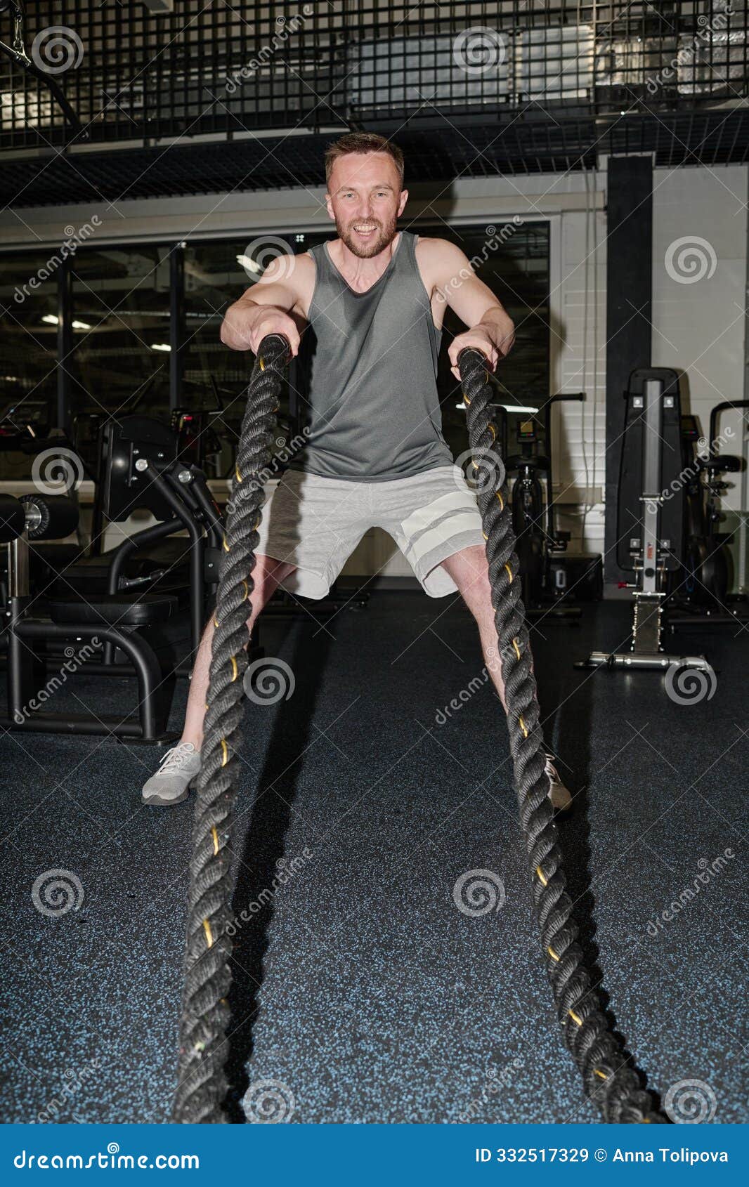 Man Using Ropes in Gym stock image. Image of effort - 332517329