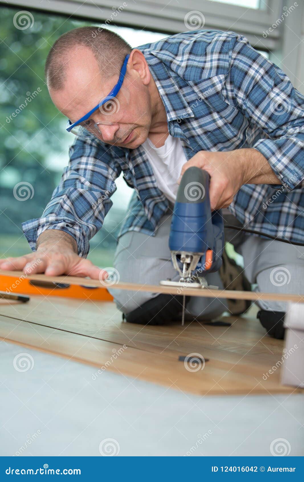Man using saw to cut wood stock photo. Image of lumber - 124016042