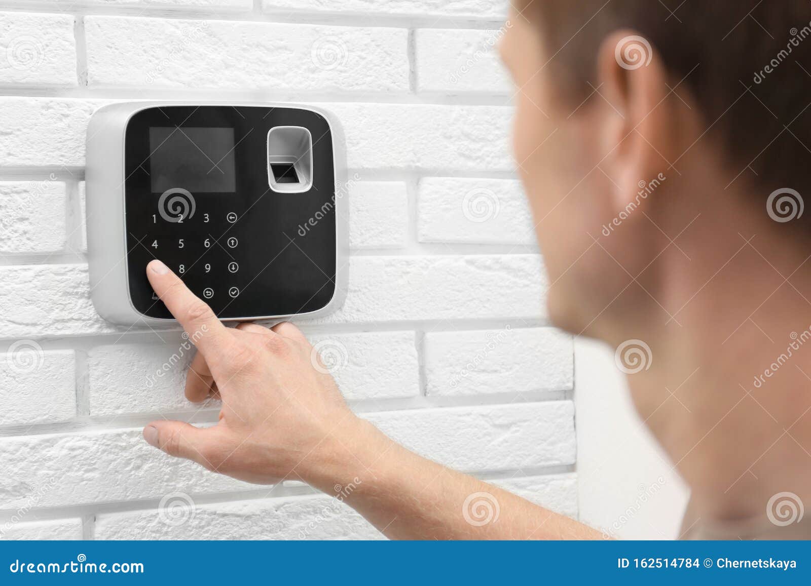 Man Using Security Alarm System Indoors Stock Photo - Image of panel ...