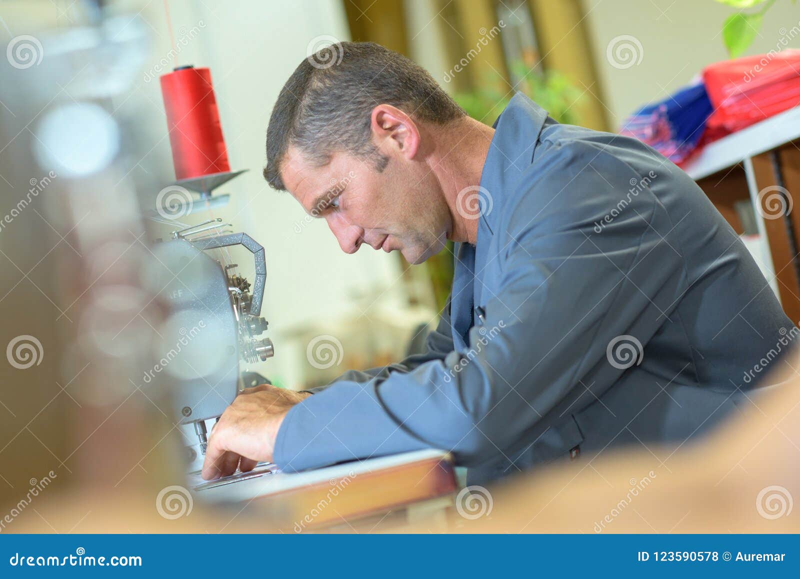 Man using sewing machine stock photo. Image of blurred - 123590578