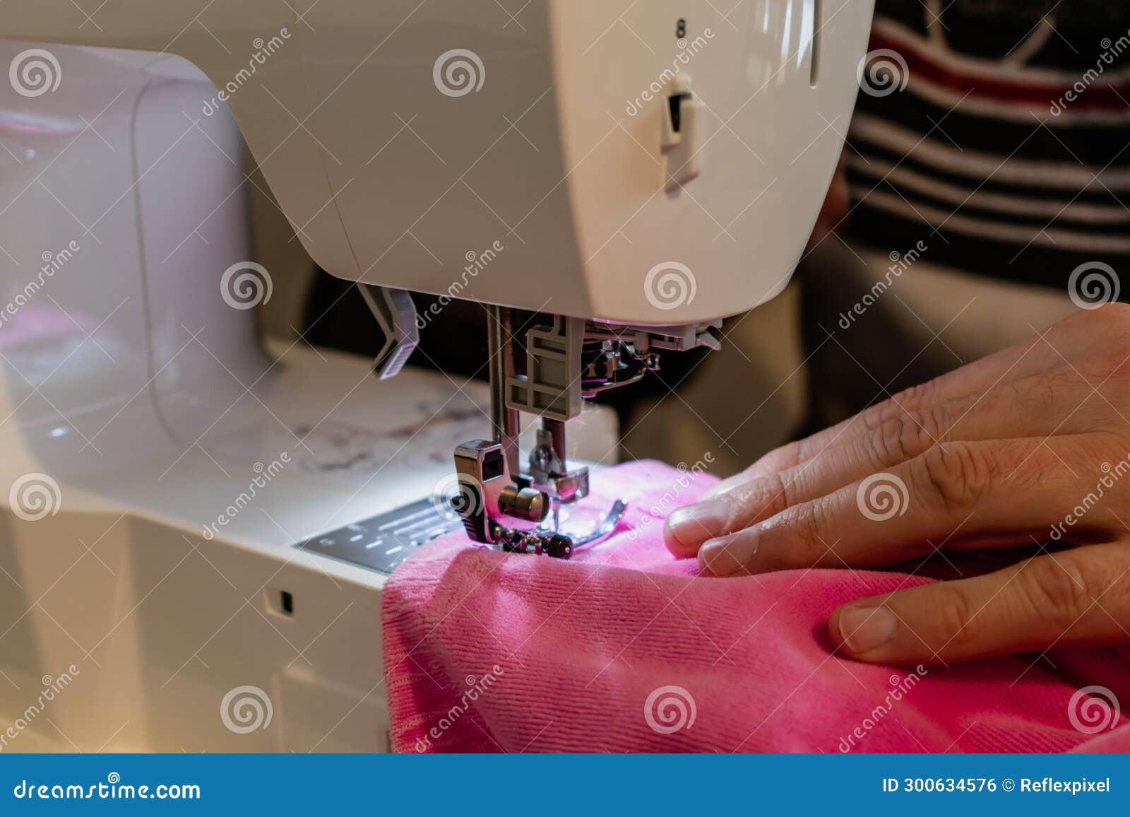 Man Using a Sewing Machine with a Pink Garment, for Repair Work ...
