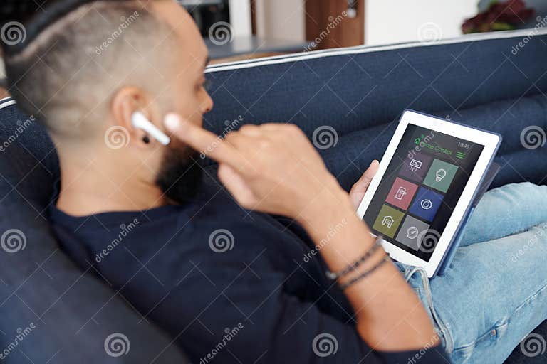 Man Using Smart Home App stock photo. Image of interface - 221841672