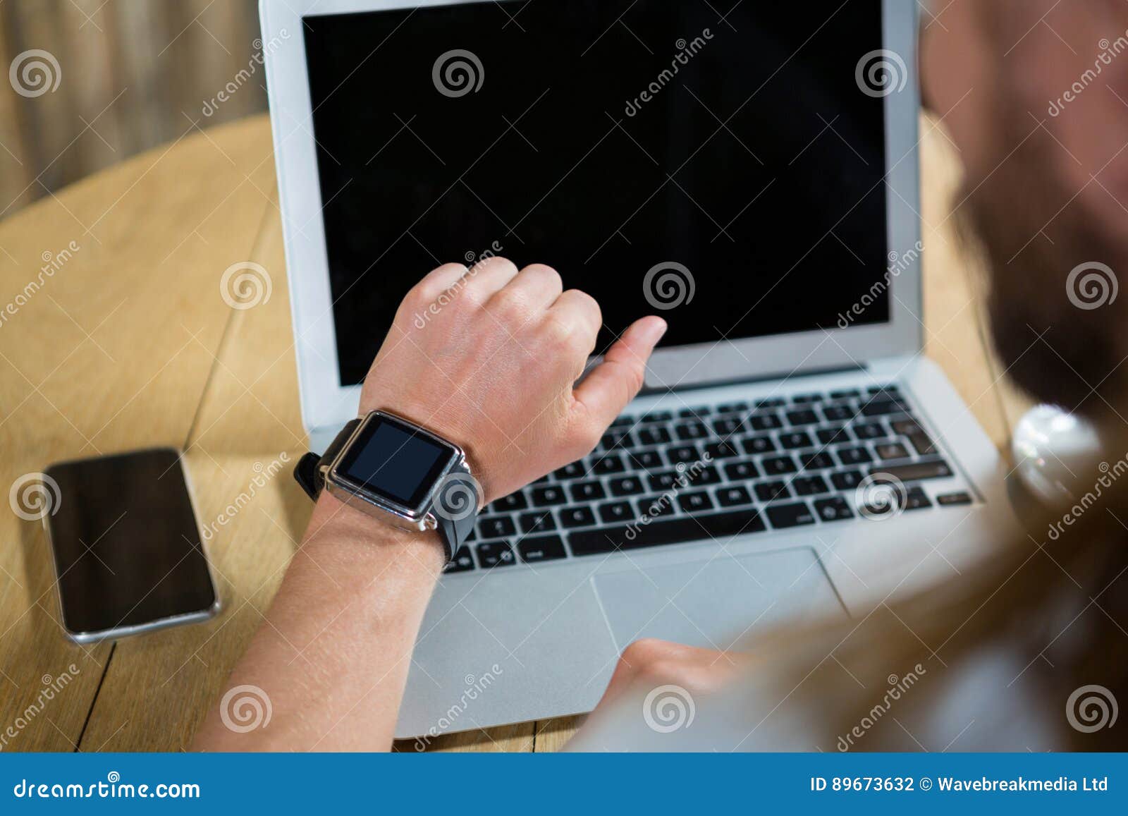 Man Using Smart Watch with Laptop and Mobile Phone on Table in Cafe ...
