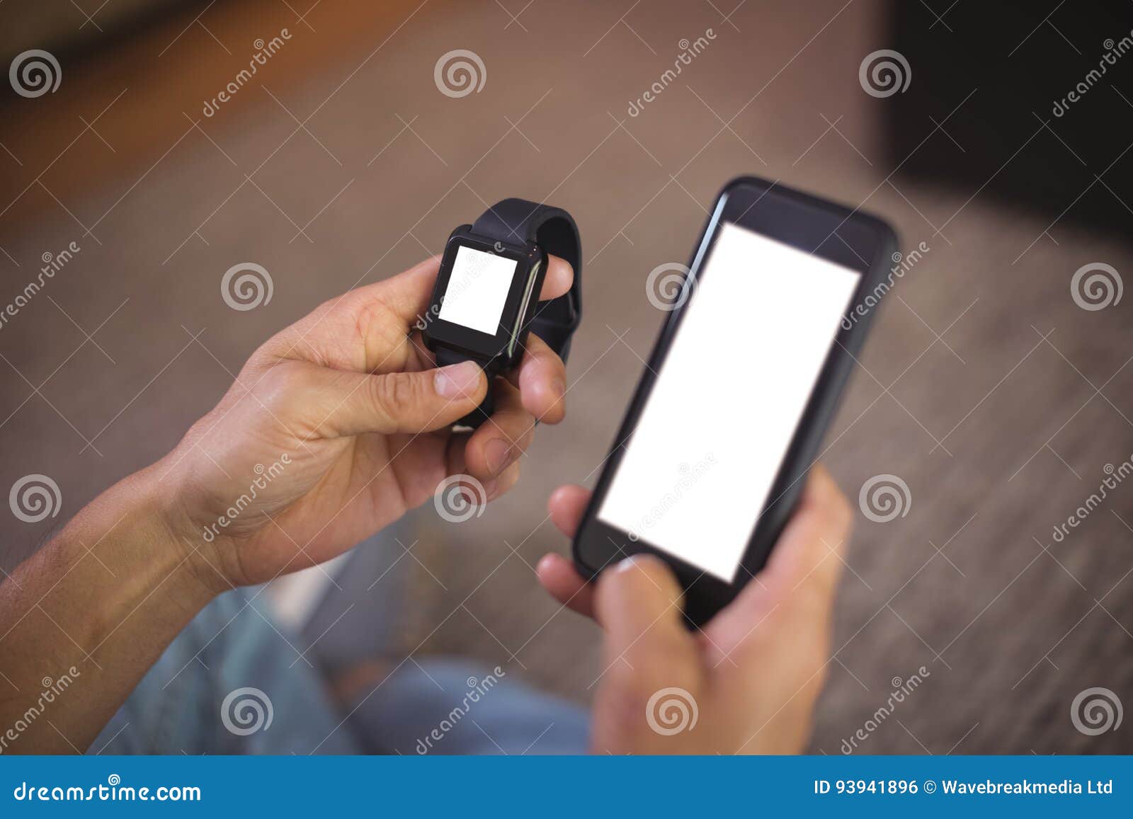 Man Using Smart Watch and Mobile Phone in Living Room Stock Photo ...
