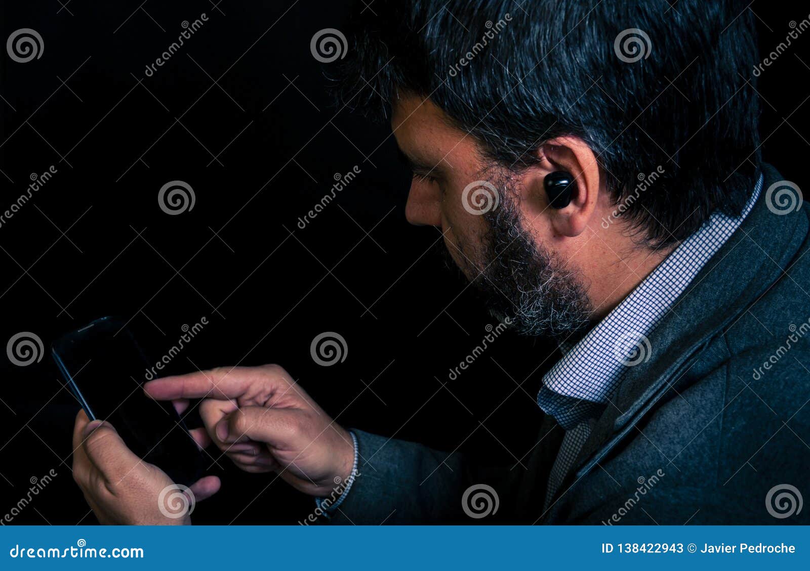 Man Using Smartphone and Bluetooth Headphones Stock Image - Image of ...