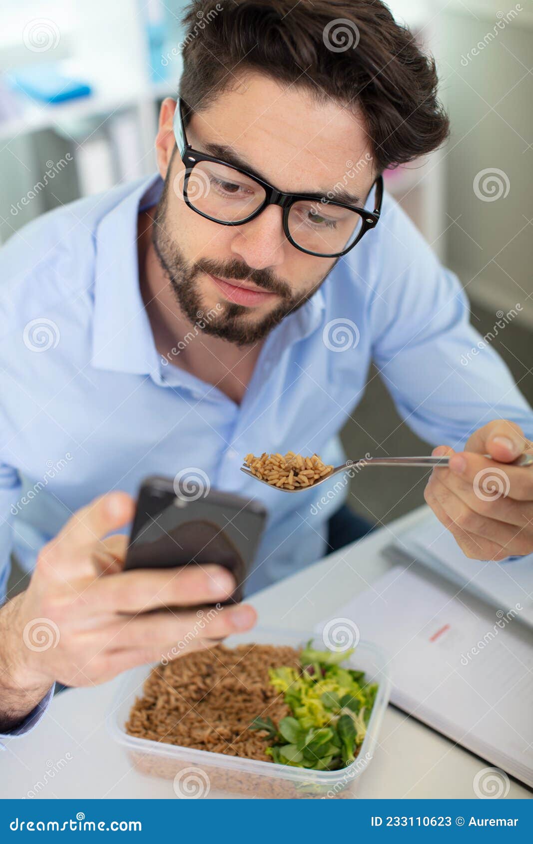 Man Using Smartphone while Eating Meal in Workplace Stock Image - Image ...