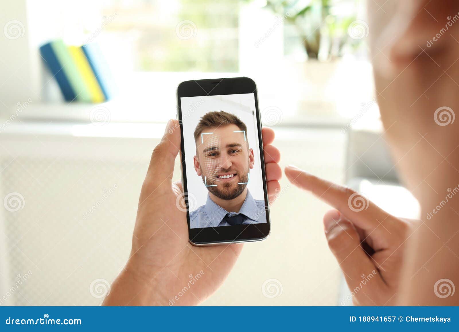 Man Using Smartphone With Facial Recognition System Indoors Biometric