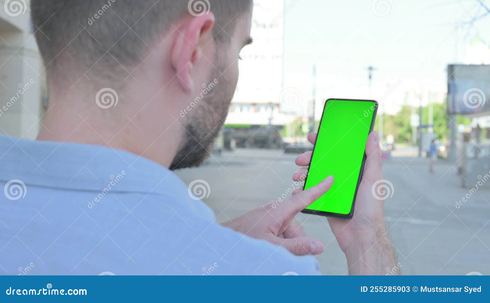 Young Man Using Smartphone with Green Screen Outdoor Stock Image ...