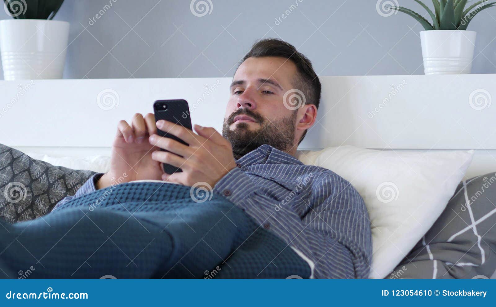 Man Using Smartphone while Lying in Bed Stock Photo - Image of internet ...