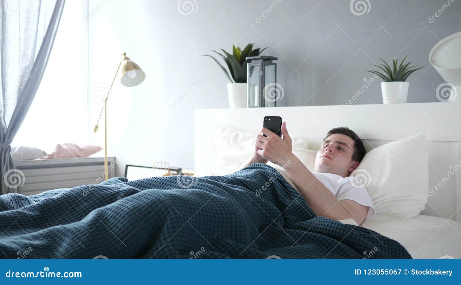 Man Using Smartphone while Lying in Bed Stock Image - Image of ...