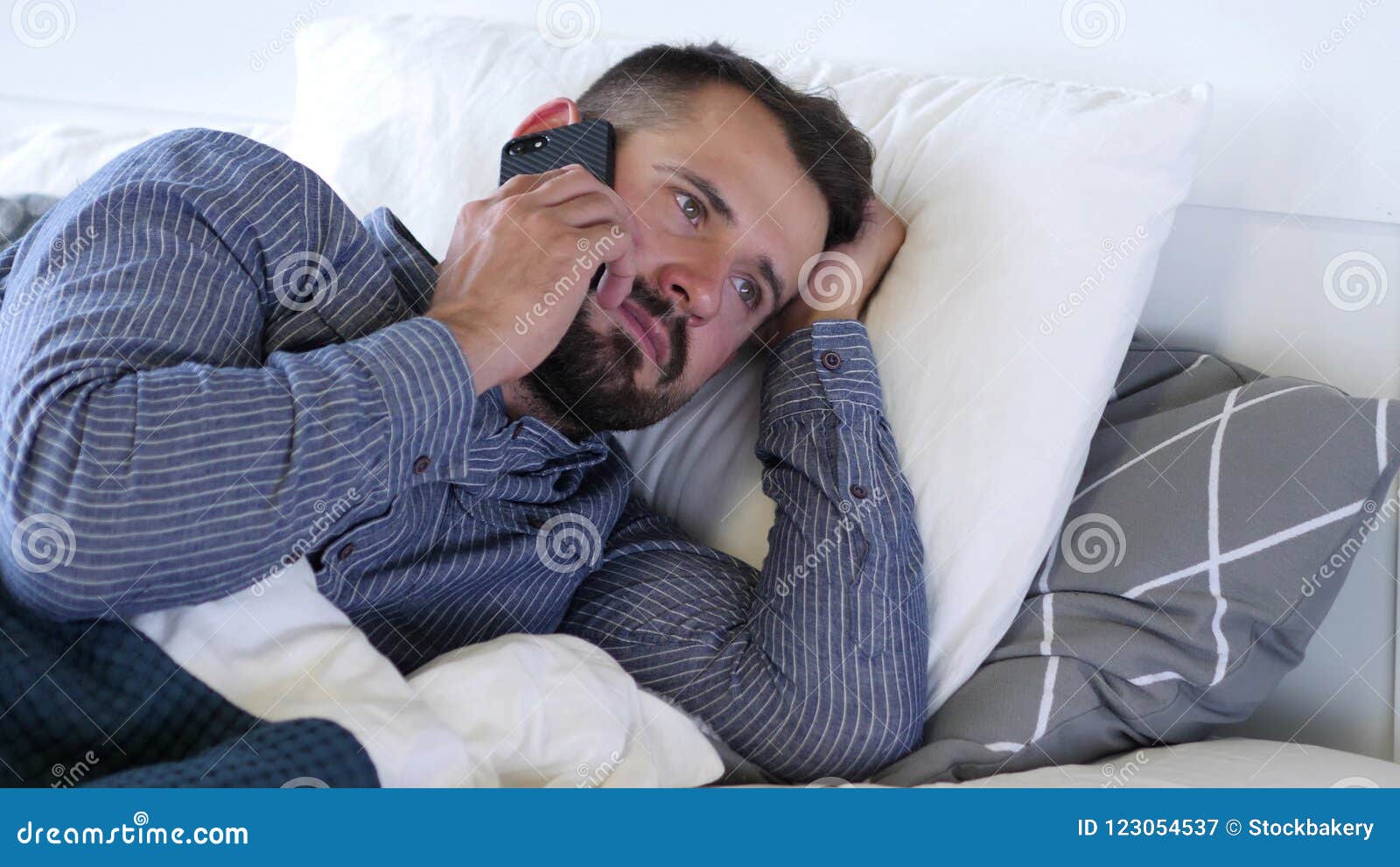 Man Using Smartphone while Lying on Side in Bed Stock Image - Image of ...
