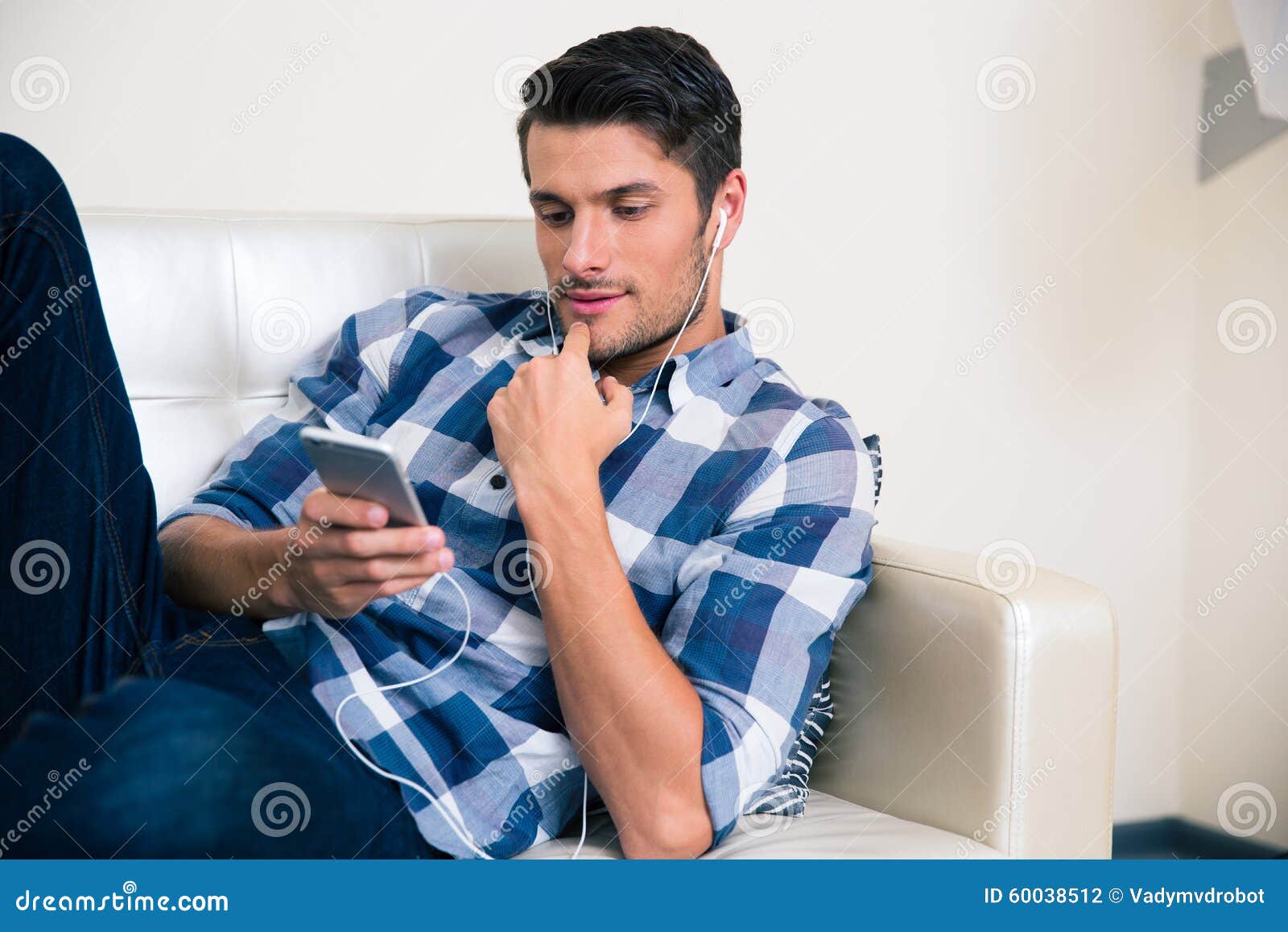 Man Using Smartphone on the Sofa Stock Photo - Image of headphones ...