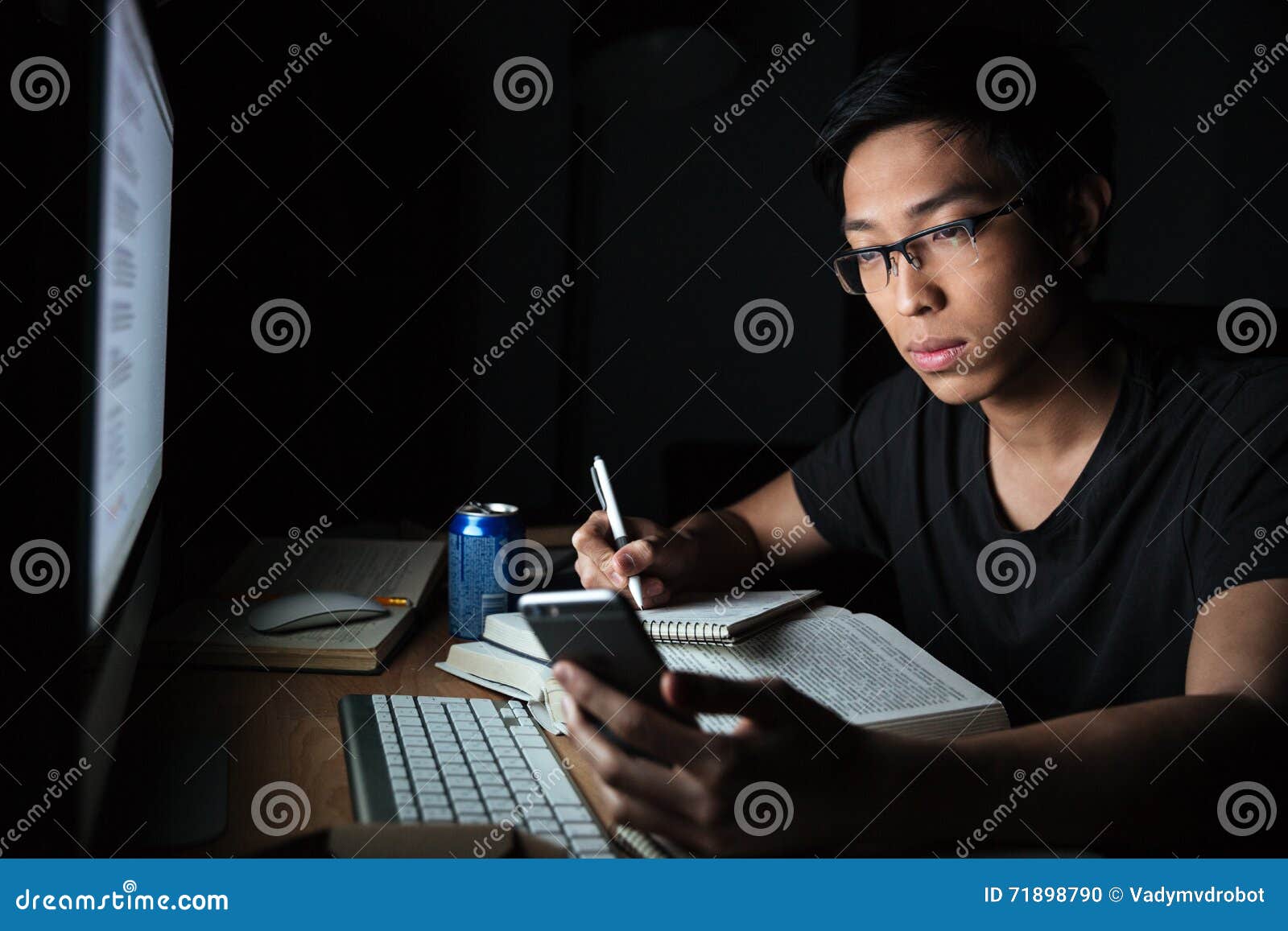 Man Using Smartphone while Studying in the Evening at Home Stock Photo ...
