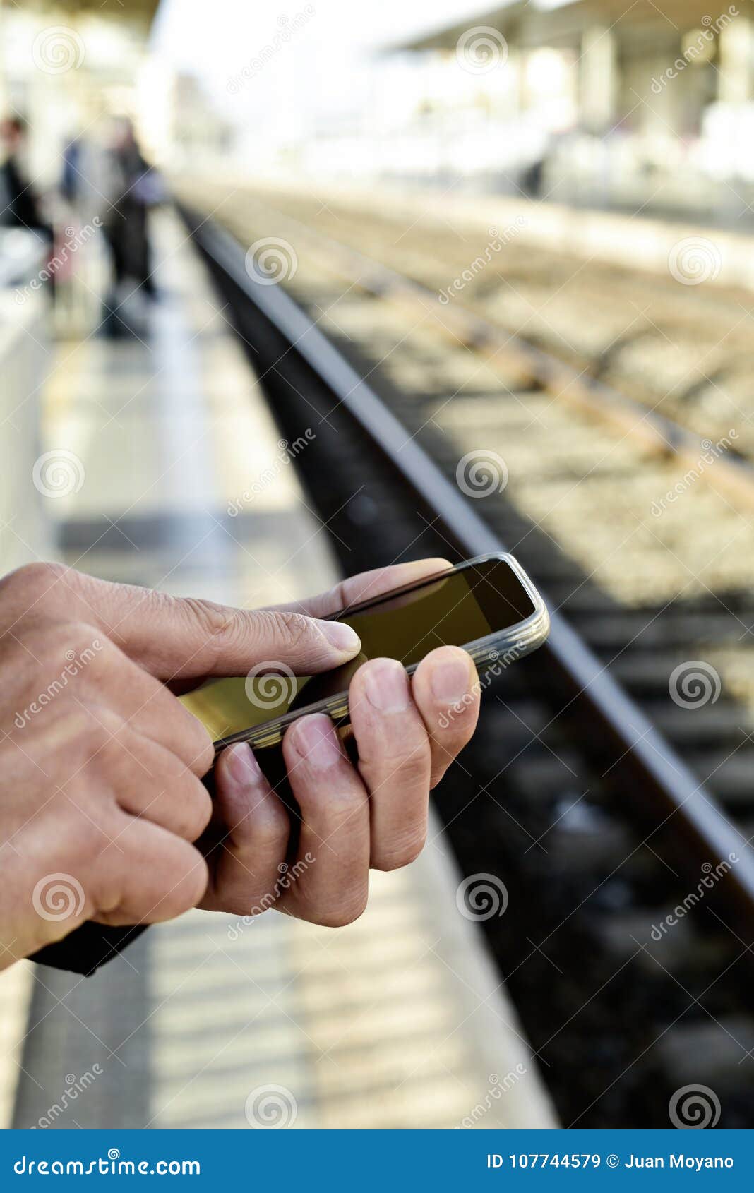 Man Using Smartphone in a Train or Tram Station Stock Image - Image of ...