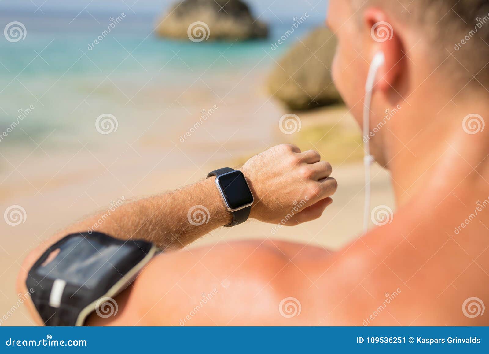 Man Using Smartwatch on the Beach Stock Image - Image of listen, health ...