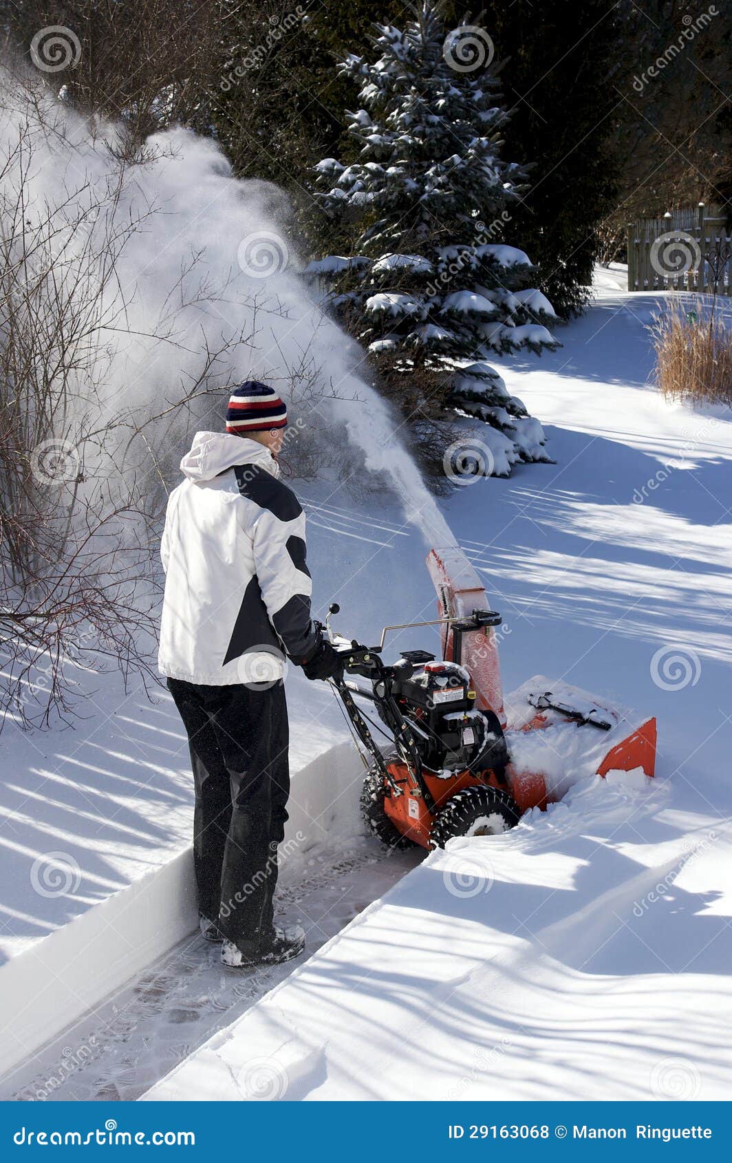 Man Using a Snow Blower stock photo. Image of striped - 29163068