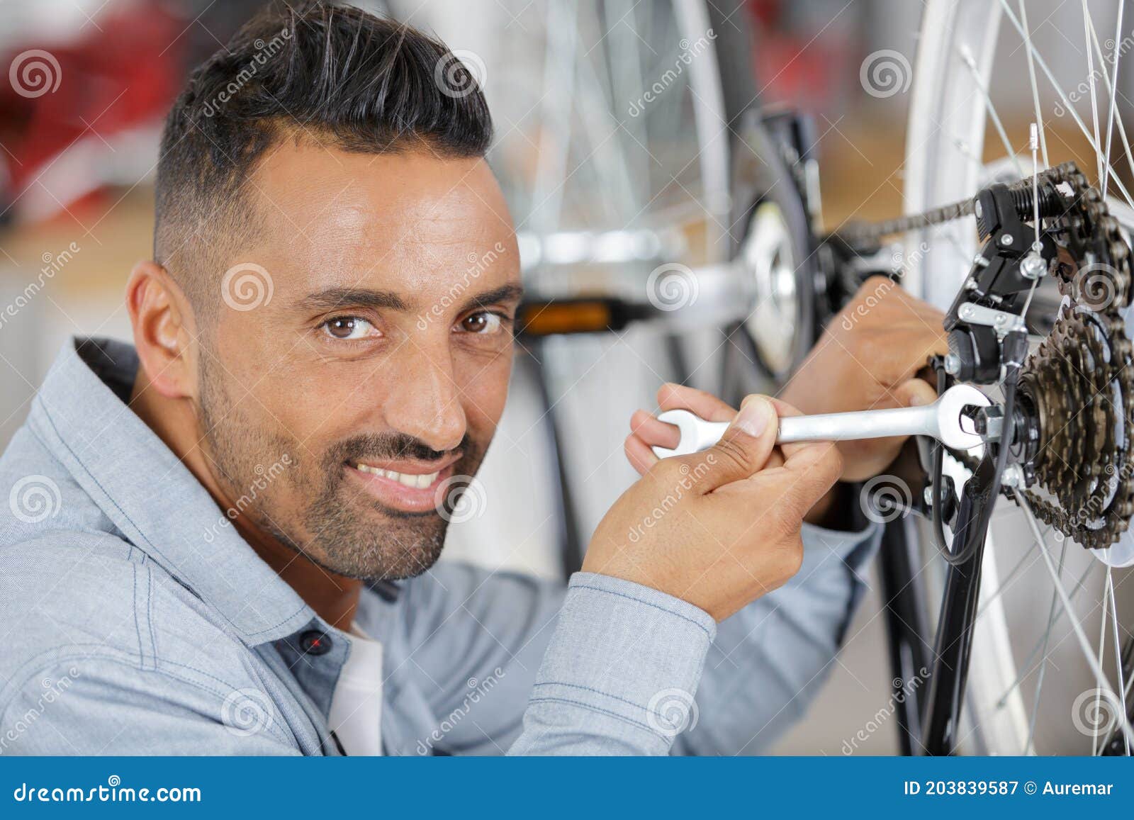 Man Using Spanner To Work on Bicycle Wheel Stock Image - Image of ...