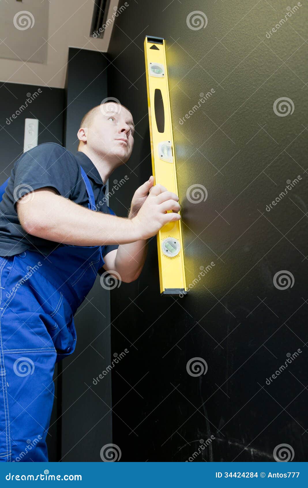 Man using a spirit level stock photo. Image of home, level - 34424284