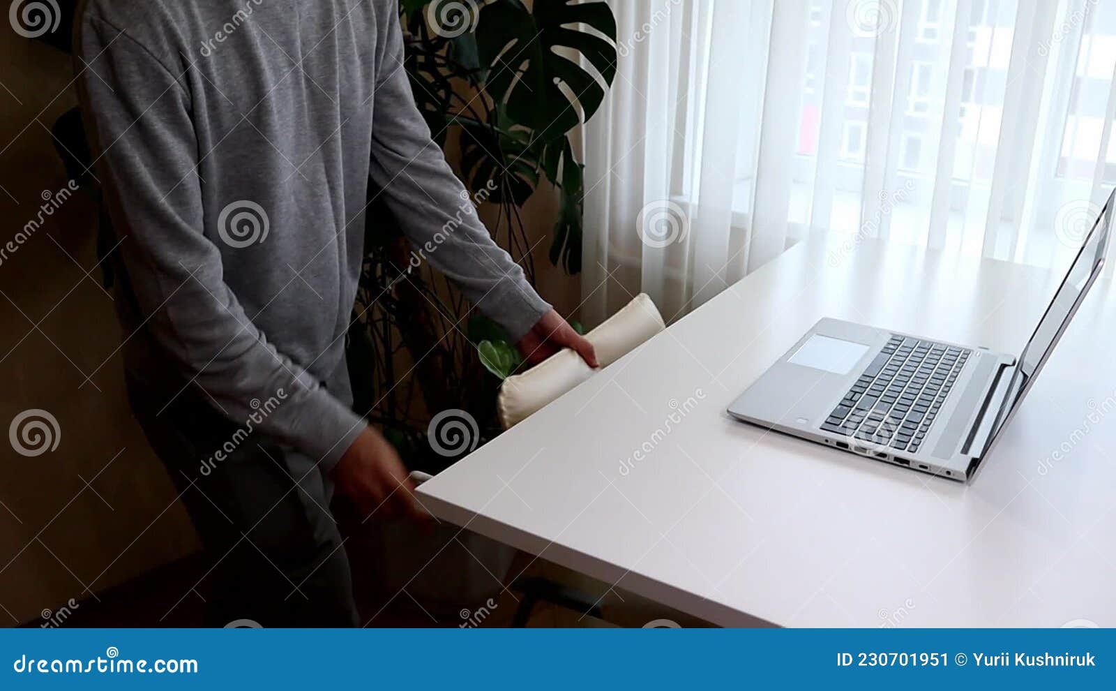 Man is Using a Standing Desk.Man is Rasing Up the Table by Turn Round ...
