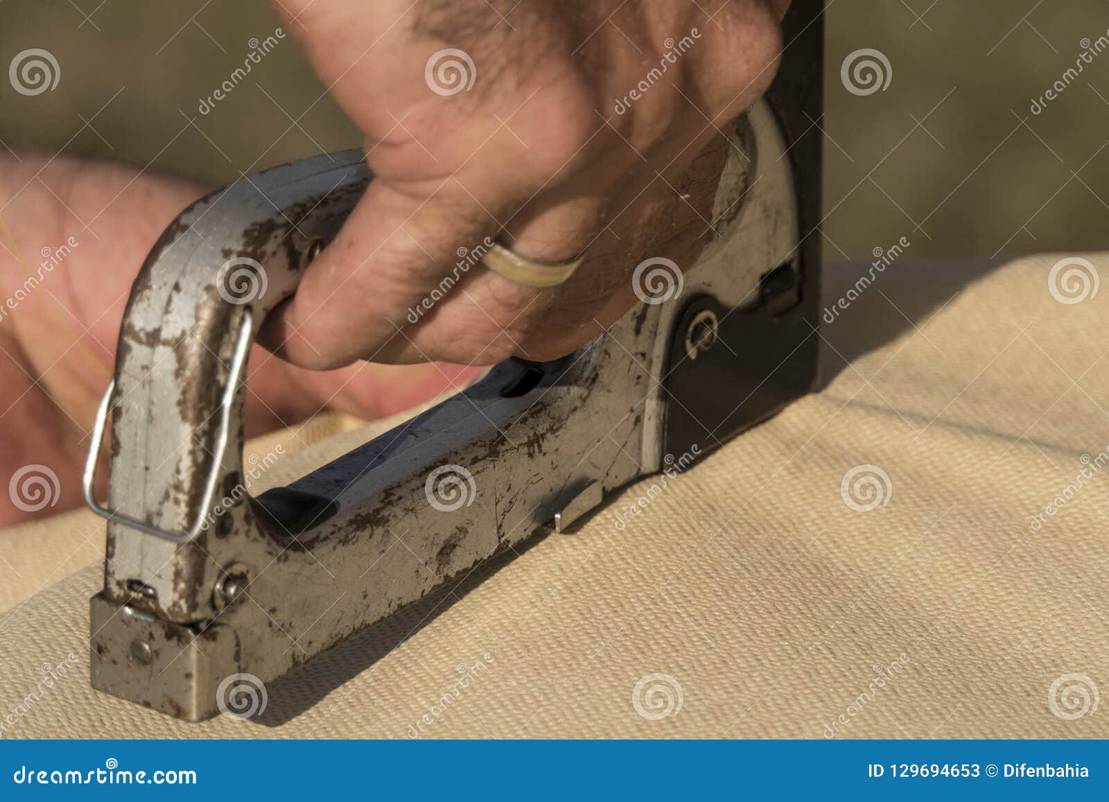 Man Using Stapler To Attach Cover Material. Stock Image - Image of ...