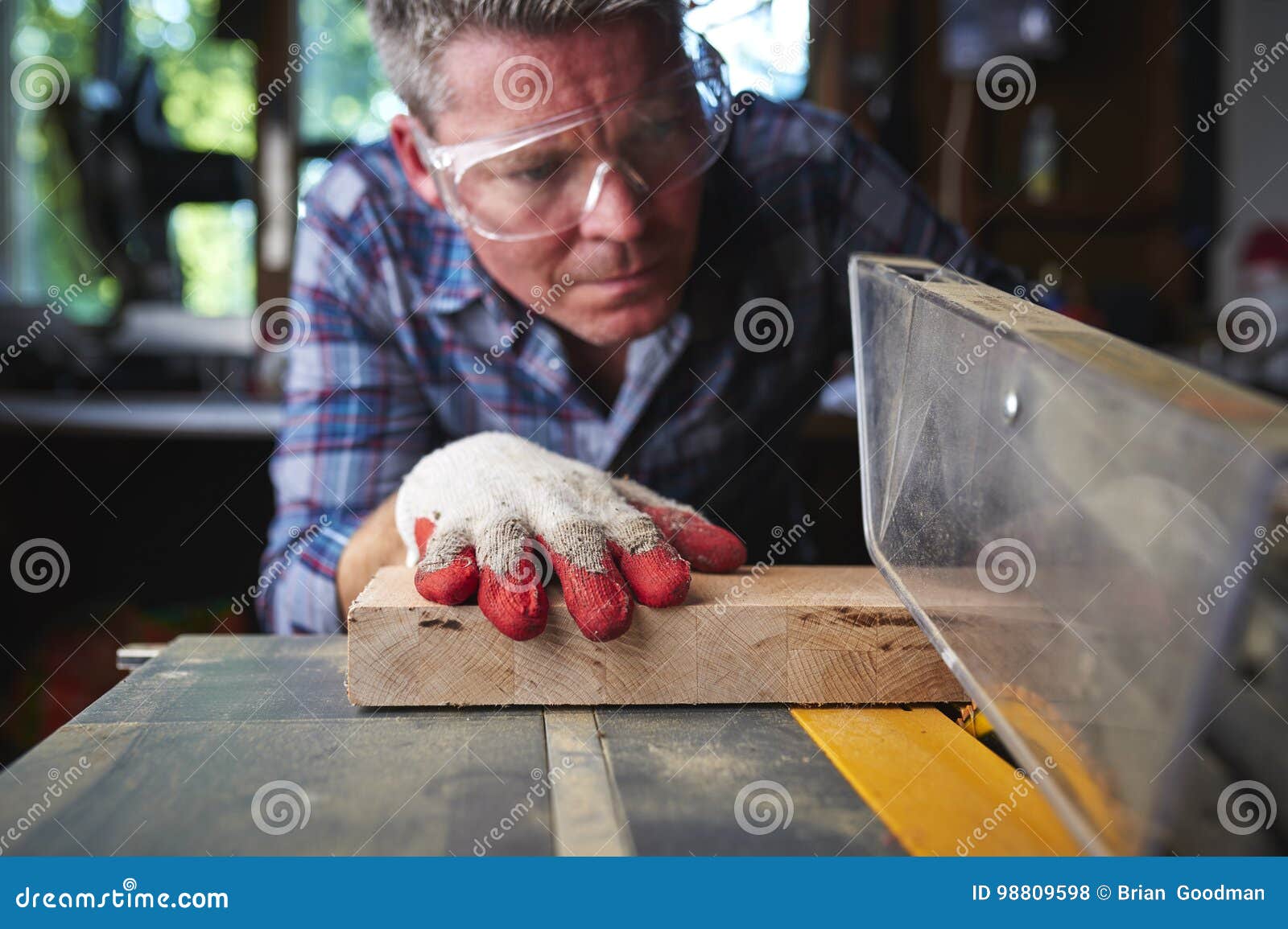 A man using a table saw stock photo. Image of craftsman - 98809598