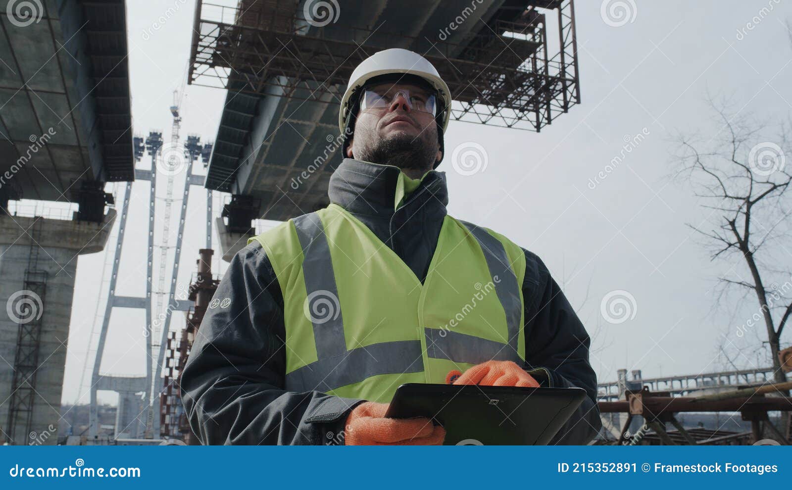 Man Using Tablet on Bridge Construction Site Stock Image - Image of ...