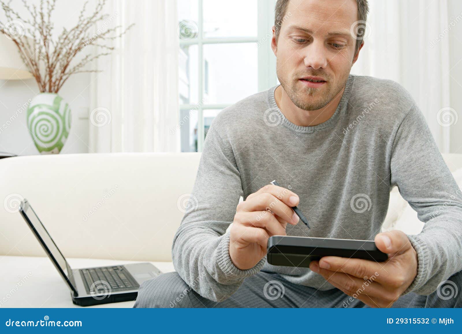 Man Using Tablet and Computer on Sofa at Home. Stock Photo - Image of ... Man Using Tablet and Computer on Sofa at Home. Stock Photo - Image of ...