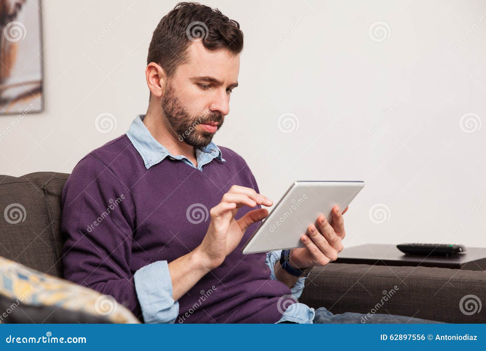 Man using a tablet at home stock photo. Image of male - 62897556