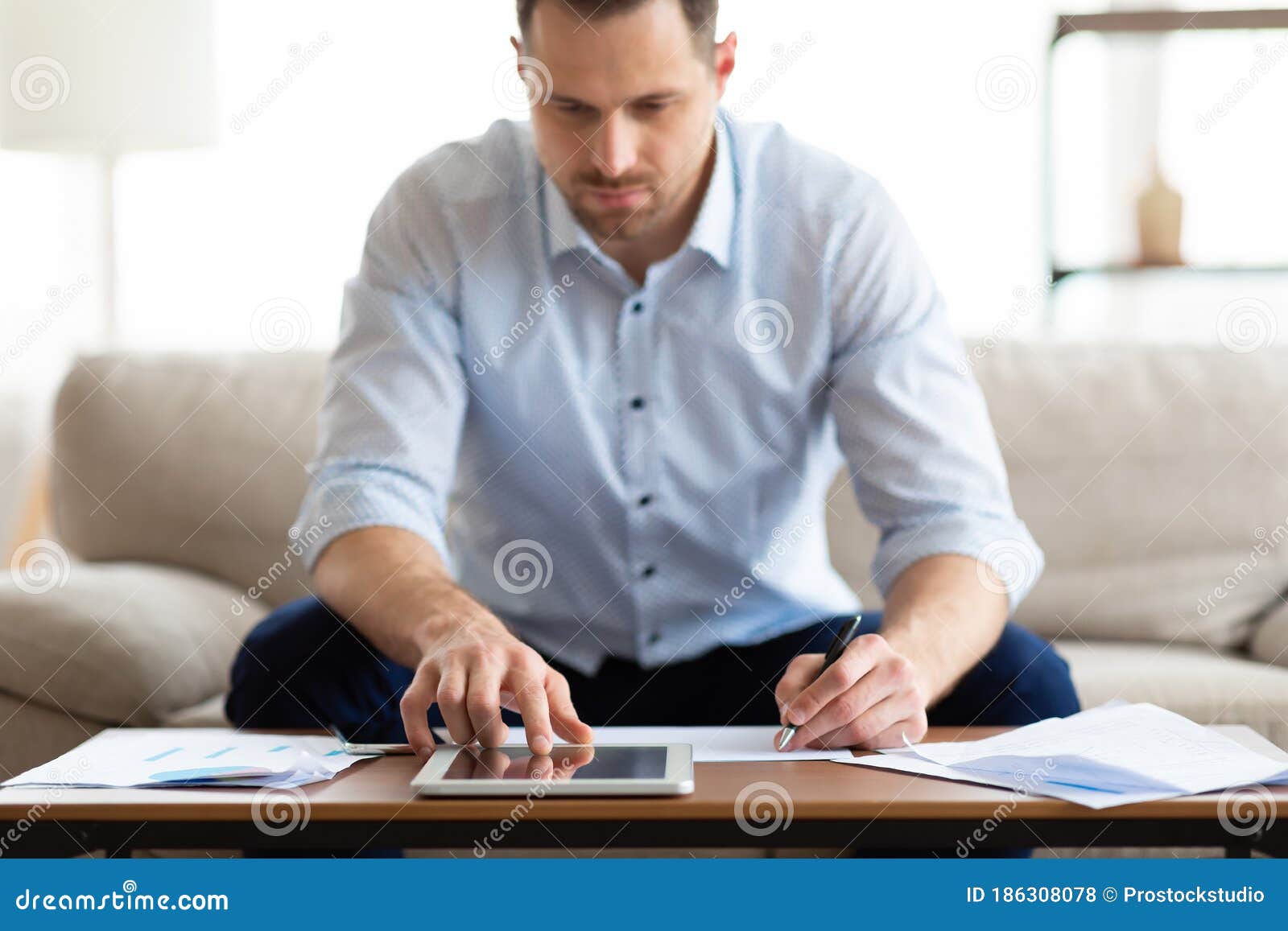 Man Using Tablet at Home and Writing Notes Stock Photo - Image of media ...