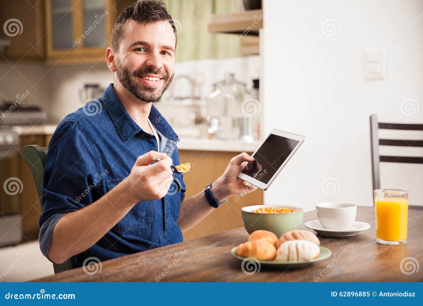Man Using a Tablet Over Breakfast Stock Image - Image of bowl, hispanic ...