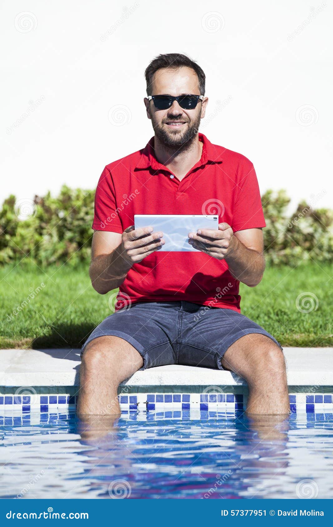 Man Using Tablet Sitting on the Poolside. Stock Image - Image of people ...