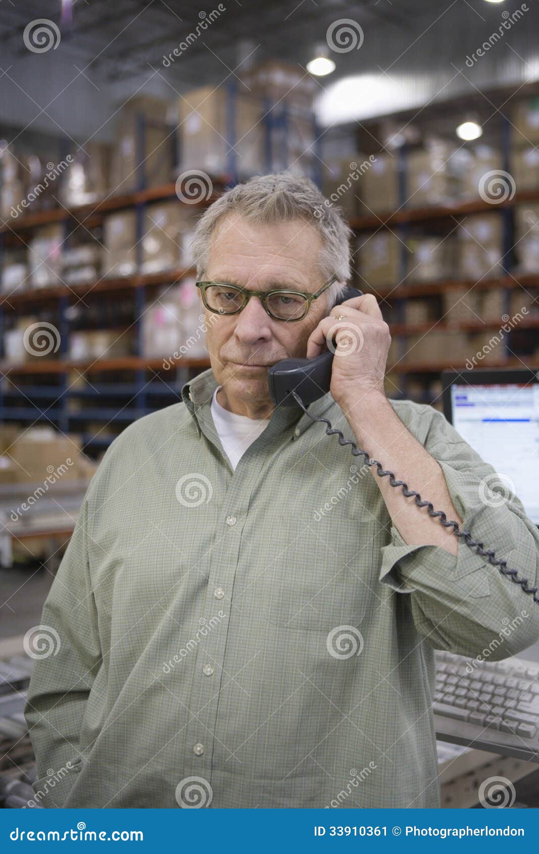 Man Using Telephone in Warehouse Stock Image - Image of person, phone ...