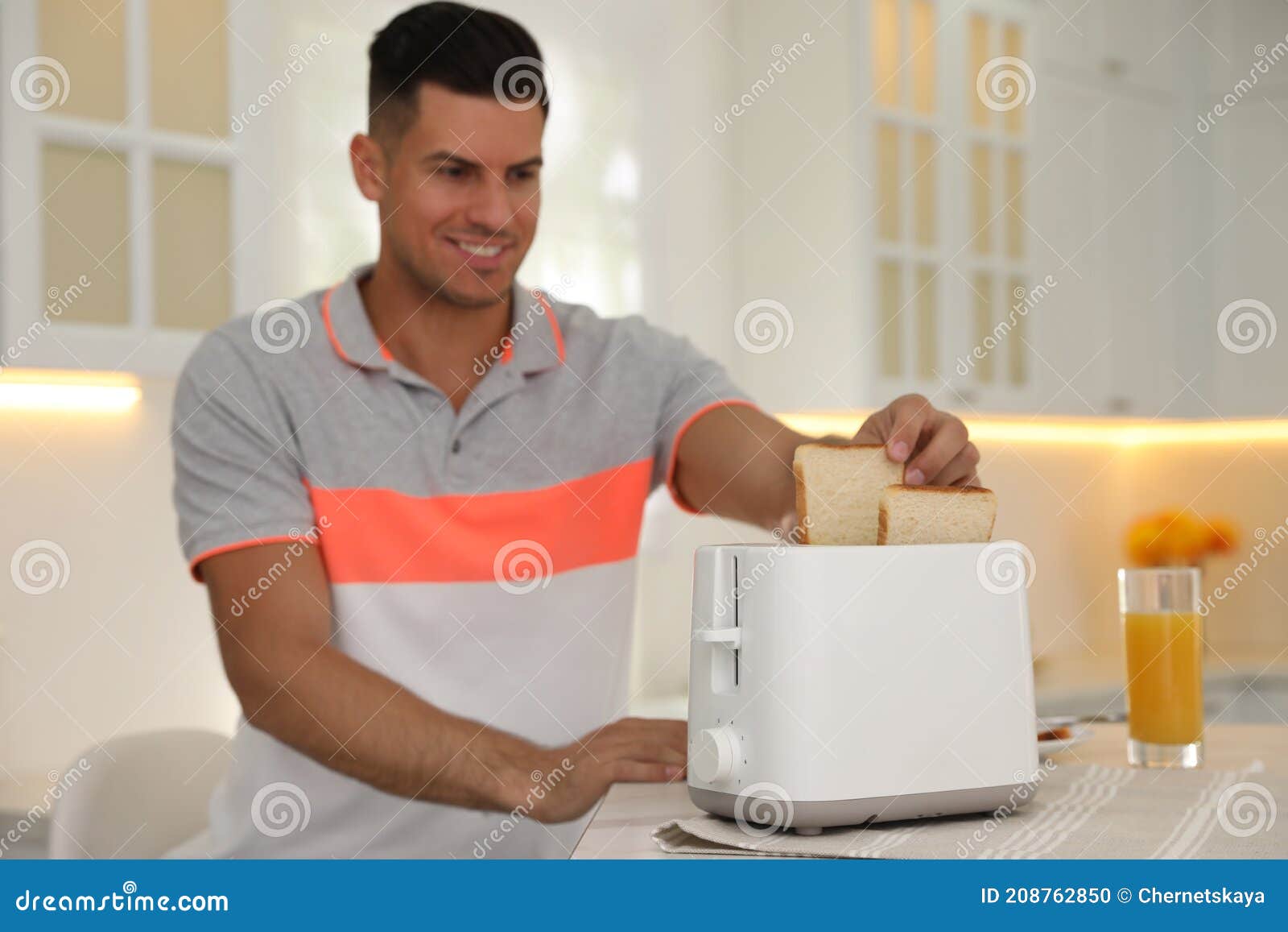 Man Using Toaster at Table in Kitchen Stock Photo - Image of cook ...