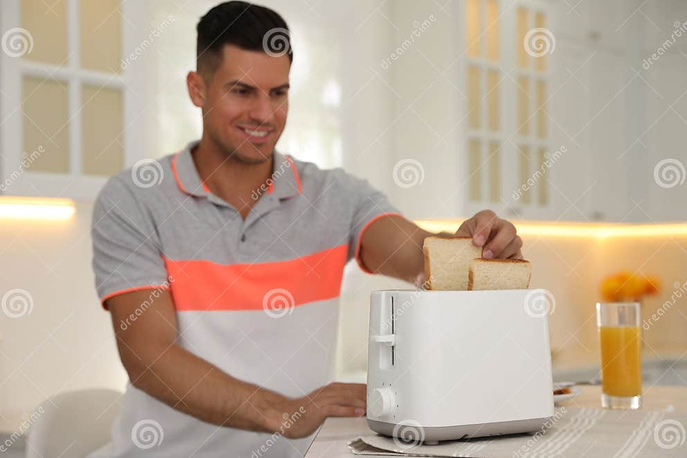 Man Using Toaster at Table in Kitchen Stock Photo - Image of cook ...